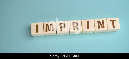 The word imprint built from letters on wooden cubes. High angle view ...