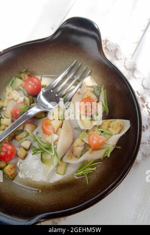 Vegan diet presentation of a plate of pasta shells seasoned with tofu ...