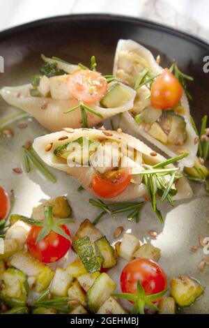 Vegan diet presentation of a plate of pasta shells seasoned with tofu ...