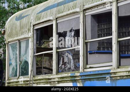 Dilapidated and rusty bus with broken windows in a remote area Stock ...