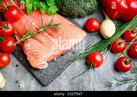 Raw fishes and vegetables on stone background, healthy food Stock Photo ...