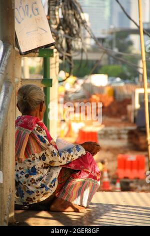 Poor elderly woman sitting on a street in Quarzazate, Morocco, Africa ...