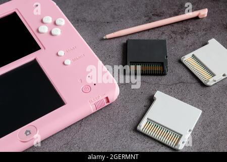 Pink portable game console with games on dark background Stock Photo ...