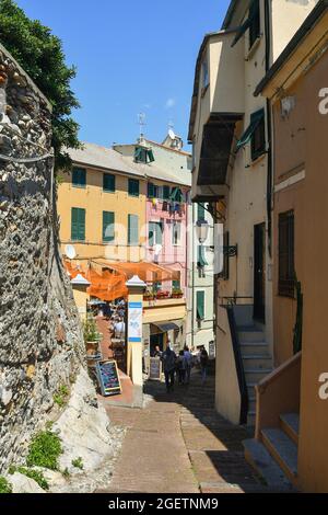 An uphill alley in the old fishing village with the Church of St ...