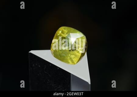 Natural rough sphene (titanite) gemstone on white background , a ...