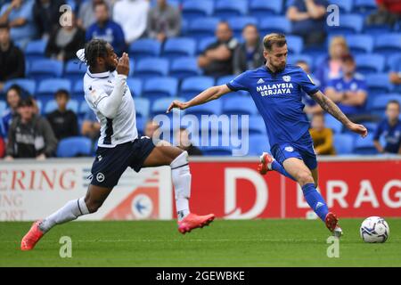 Mahlon Romeo of Millwall crosses the ball with Craig Forsyth of Derby ...