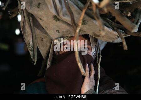 Palestinians walk in Gaza City during heavy fog on December 22, 2020 ...