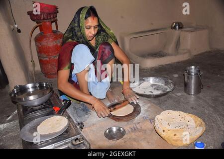 Rural Indian Woman cooking food in the Kitchen using firewood stove ...