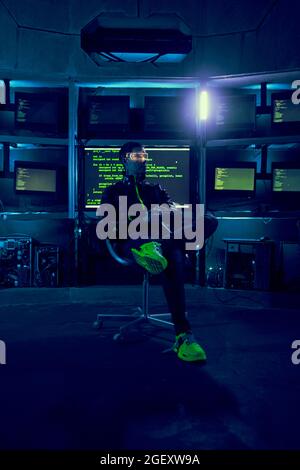 Cyber hacker breaks into databases to obtain information using a computer. Cybercrime and data ...