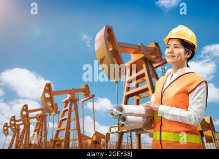 Oil rig engineer or technician wear safety helmet and reflective vest ...