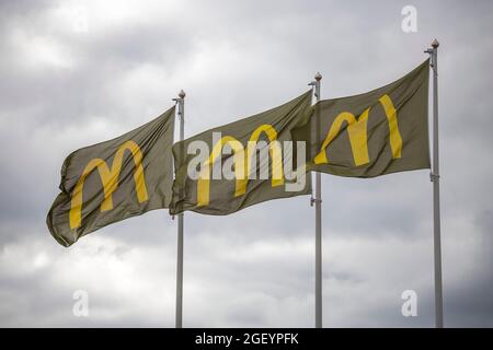 McDonald's logo flag flying in the breeze outside a McDonald's ...