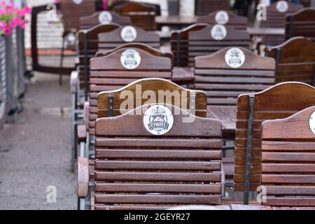 Zywiec branded chairs in a beer garden on a rainy day Stock Photo - Alamy