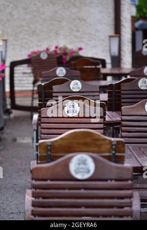 Zywiec branded chairs in a beer garden on a rainy day Stock Photo - Alamy