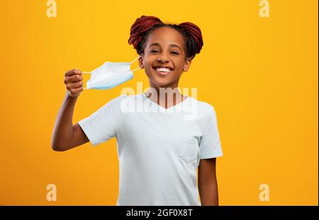 pretty african american girl taking selfie on smartphone in bed during ...