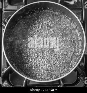 steam rising from fry pan while cooking food closeup, shallow focus ...