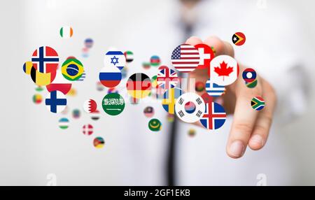 A man holding the virtual 3D national flags of different countries ...