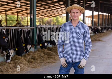 Male farmer posing in cowshed at the cow farm Stock Photo - Alamy