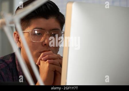 Pensive software developer searching for bugs in programming code Stock Photo - Alamy