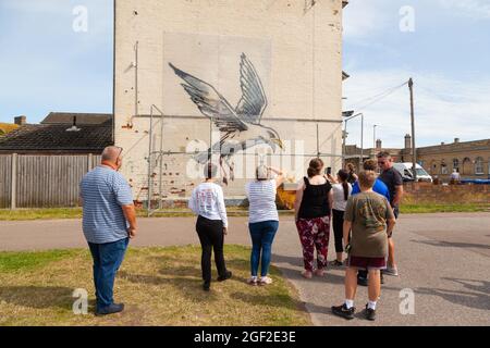 Crowds gathering round Banksy's Seagull street art piece at Lowestoft ...