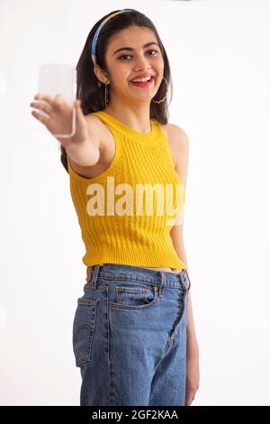 Portrait of young asian woman cover one side of face, looking with one ...
