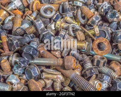A closeup shot of random metal rusty scrap on rocky surface outdoors on ...