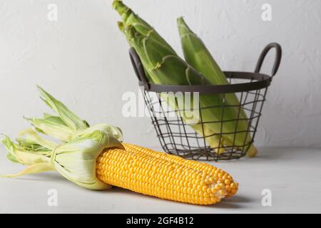 Fresh corn cobs on light background Stock Photo - Alamy