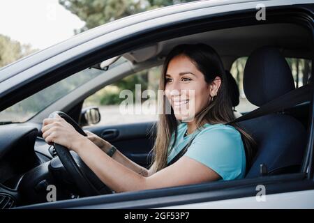 Beautiful Smiling woman driving car, attractive girl sitting in ...