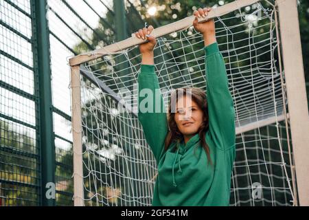 People hanging from a goal post Stock Photo - Alamy