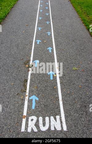 A direction arrows with RUN instruction on asphalt road Stock Photo - Alamy