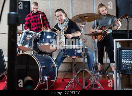 Rehearsal of music group with female drummer Stock Photo - Alamy