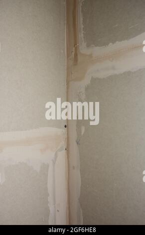 Plastering drywall corner: A close-up on plastering a drywall partition ...