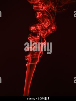 Wisp of red smoke spiraled abstract steaming maroon background, steam ...