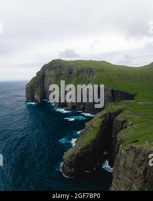 Aerial view, Asmundarstakkur cliff, Sandvik, Suduroy, Faroe Islands ...