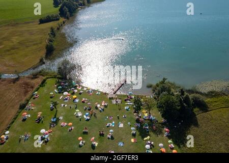 Drone shot, bathing place with colourful sunshades at the Irrsee, Zell ...