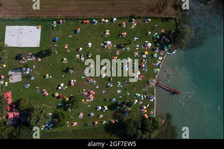 Drone shot, bathing place with colourful sunshades at the Irrsee, Zell ...