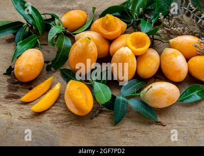 Fresh marian plums sweet yellow or mayong-chit with green leaf isolated ...