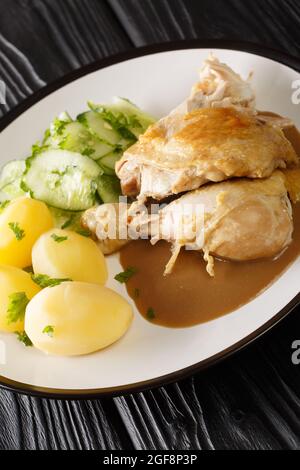 Danish fried old-fashioned chicken with boiled potatoes and cucumber ...