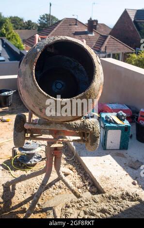 Building using a portable cement concrete mixer being used at a ...