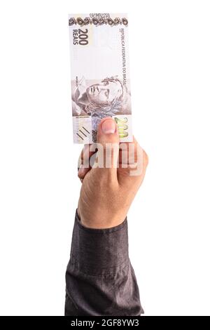 Man holding real Brazilian money banknotes Stock Photo - Alamy
