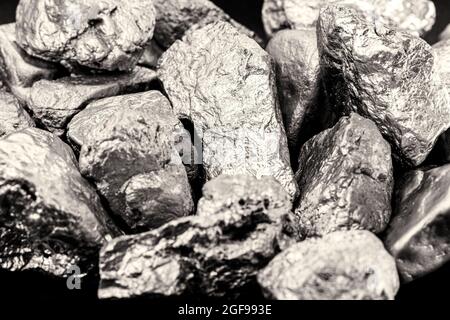 Cassiterite, tin oxide mineral, tin ore isolated on black background ...