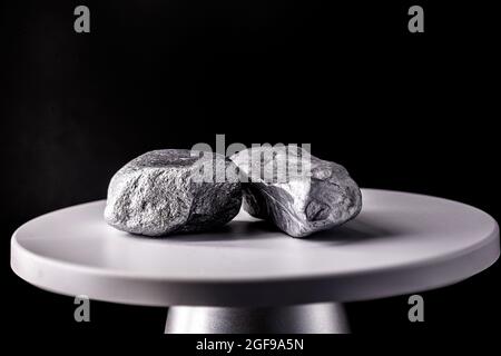 Manganese stones on electronic scale. Metal used in industry. Mineral ...