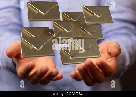 Businessman holding a 3d render of floating gold communication icons ...