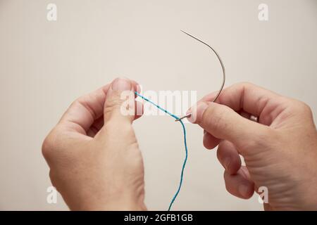 Man threads the needle Stock Photo - Alamy