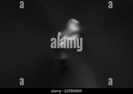 Screaming human face pressing through fabric as horror background Stock ...