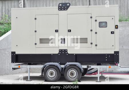 Portable gas generator providing emergency power supply on a snowy city ...