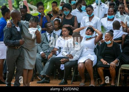 Family members grieve during the funeral of Dilip Patel and Meena Patel ...