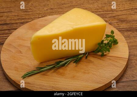 Hard cheese piece served rosemary and basil Stock Photo - Alamy