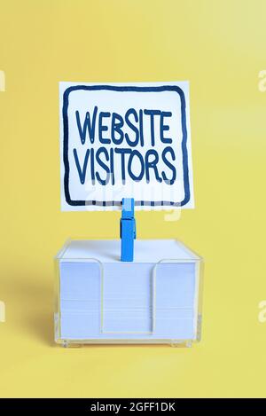 Hand writing sign Website Visitors. Word Written on someone who visits ...