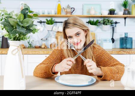 Woman Looking In Empty Food Cupboards Stock Photo - Alamy