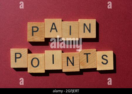 Pain Points, words in wooden alphabet letters isolated on blue ...